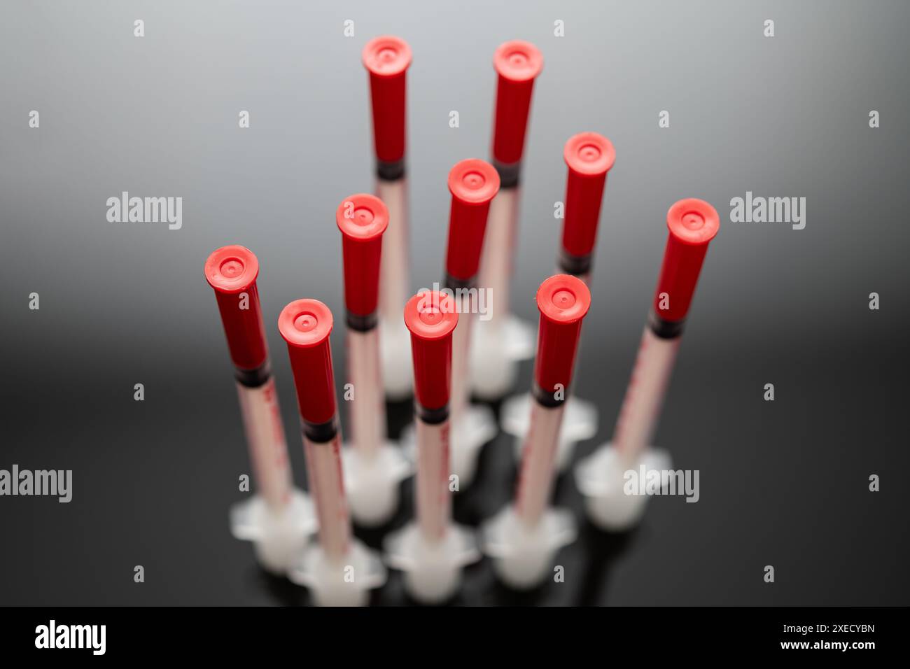 Close-up View of Multiple Blood Sample Tubes on a Reflective Dark ...