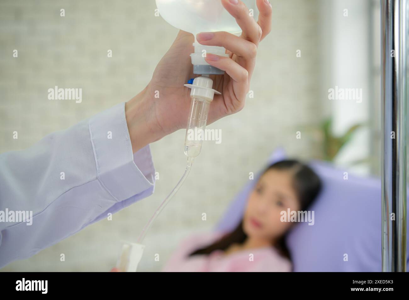 Female doctor with IV equipment will give IV fluids and examine ...