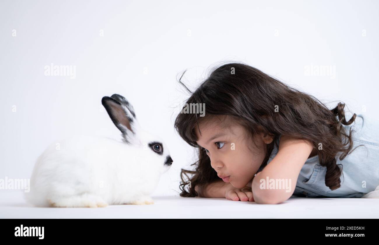A little girl kisses her beloved fluffy rabbit, The beauty of ...