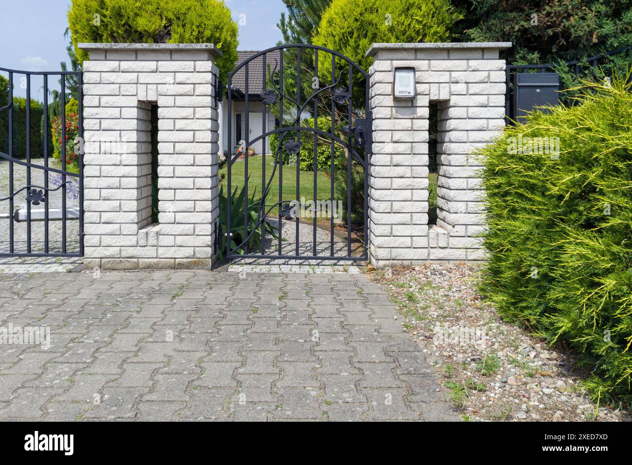 Brick Gate with Wrought Iron Fence Stock Photo - Alamy