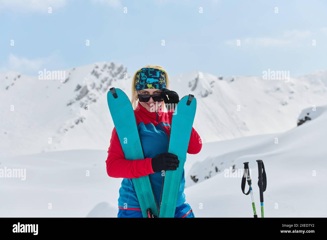 A professional woman skier rejoices after successfully climbing the ...