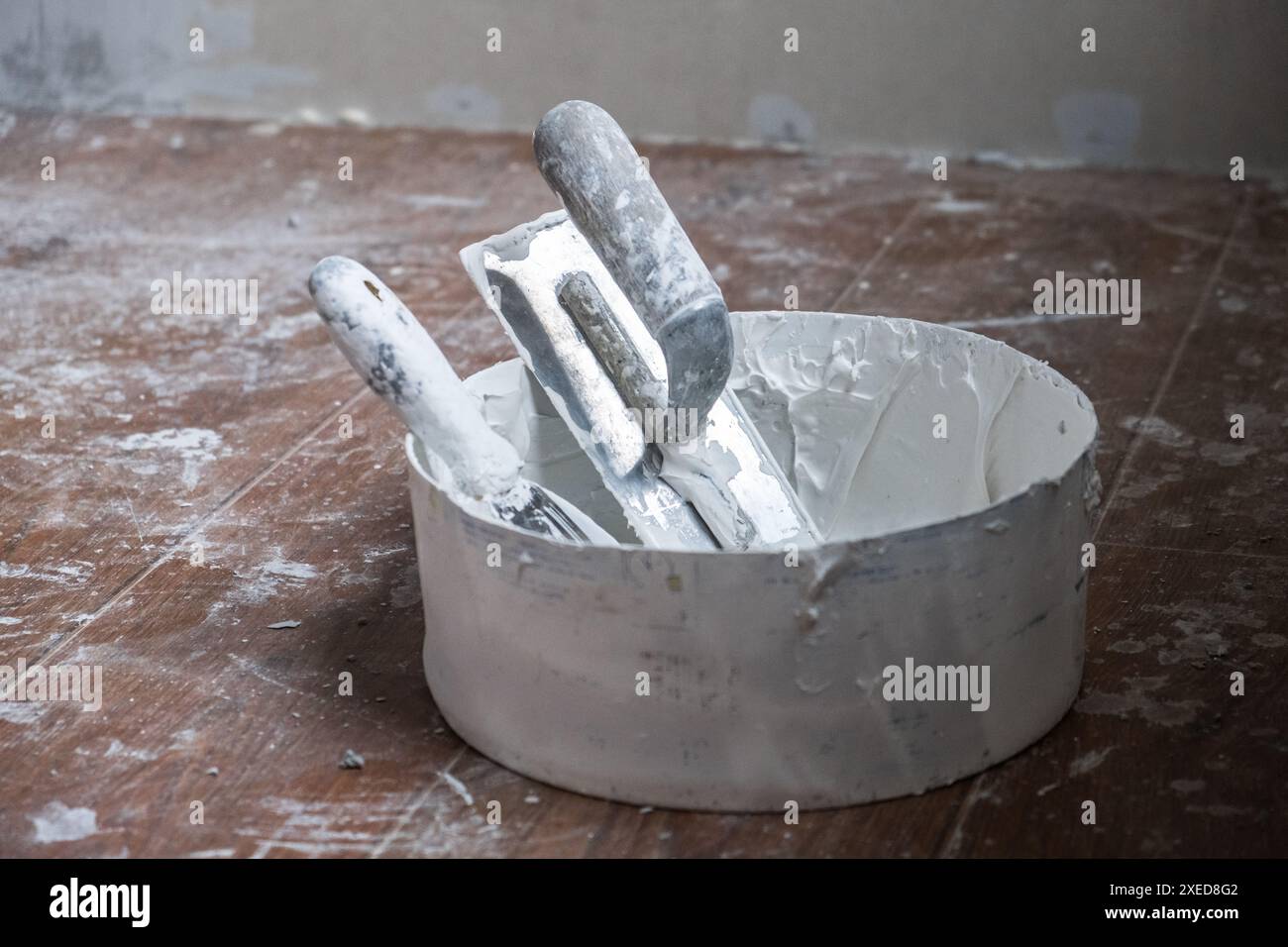 Applying decorative putty. White abstract texture of surface covered ...