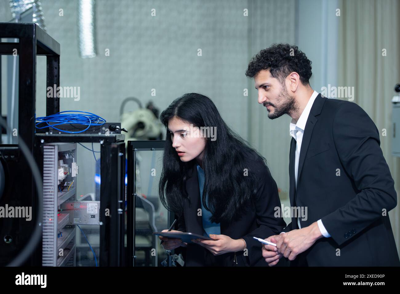 Businessperson of factory industry inspection and testing of robots arm ...