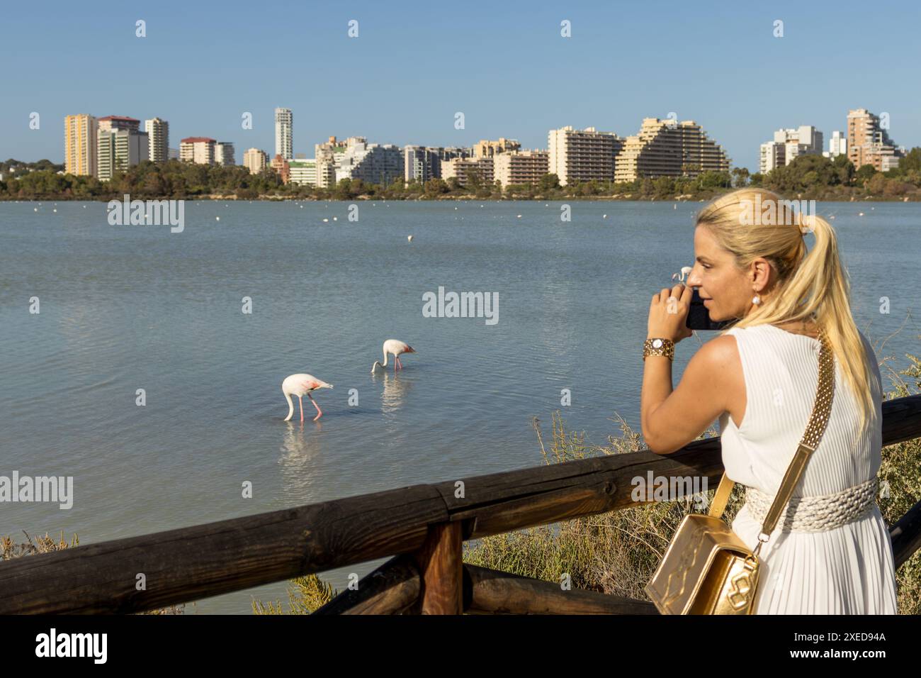 This image beautifully captures a blonde woman engrossed in ...