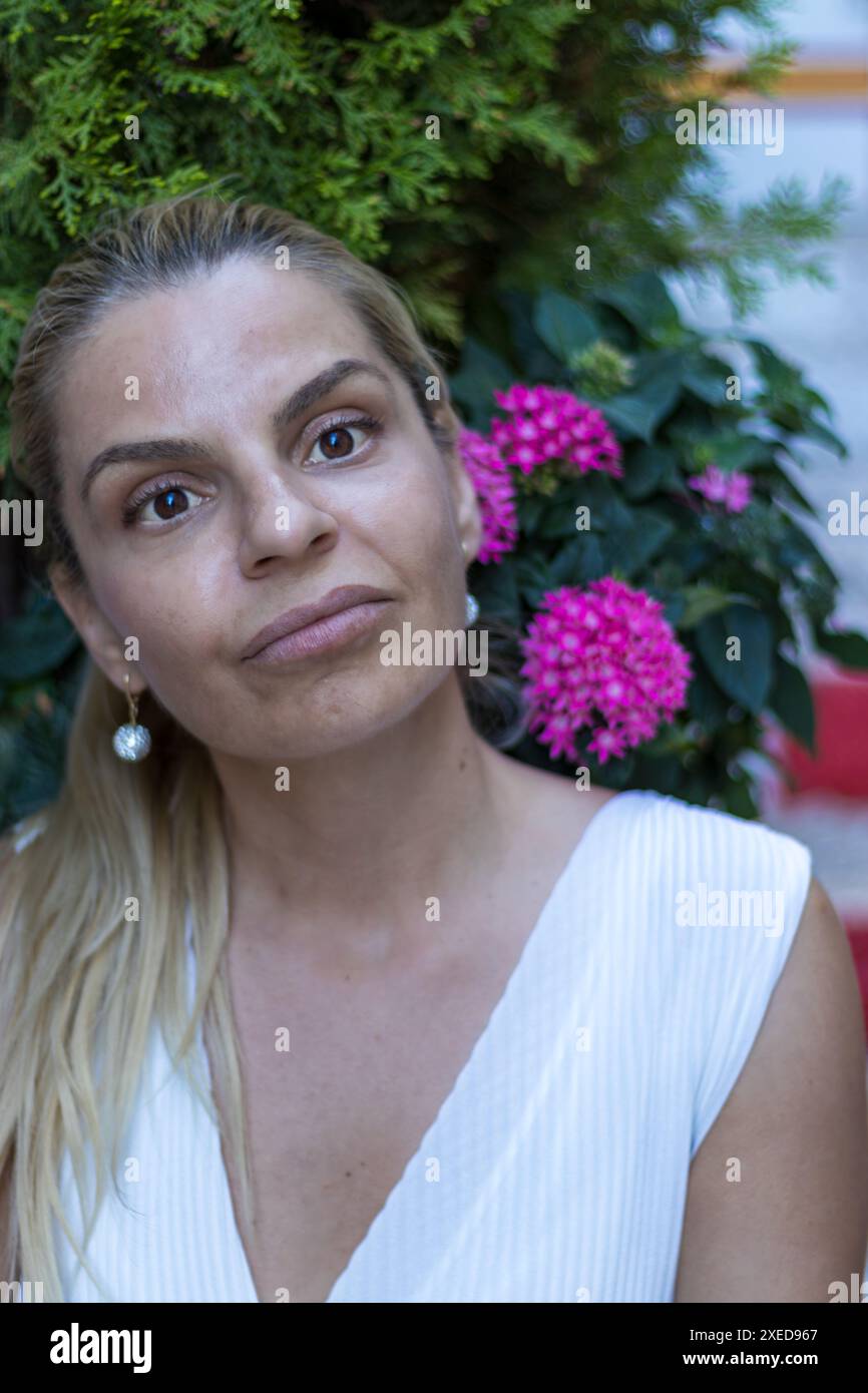 This captivating image showcases a blonde woman whose face is obscured ...
