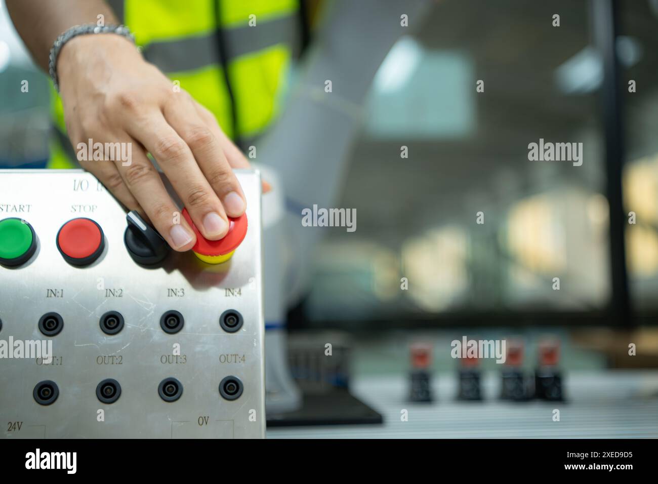 Close-up of hand pressing the stop button on the control panel of an ...