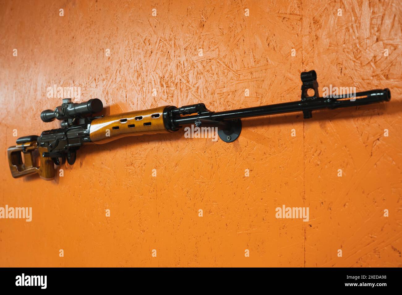 Russian sniper rifle SVD on an orange background at a shooting range ...