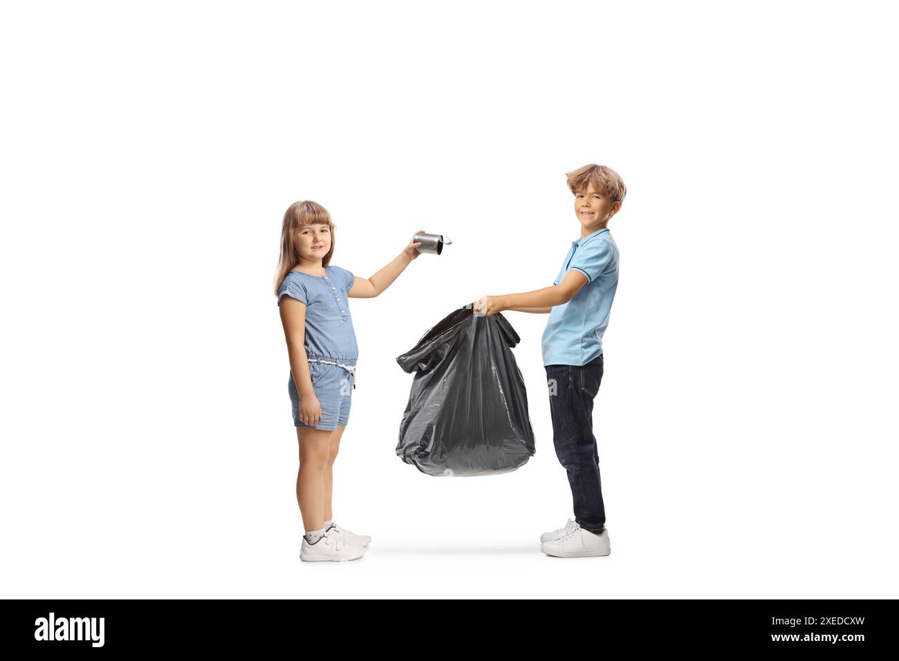 Boy holding a plastic waste bag and girl throwing a tin can isolated on ...