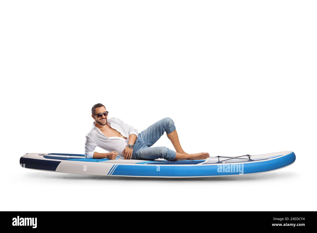 Man in jeans and white shirt sitting on a SUP isolated on white ...
