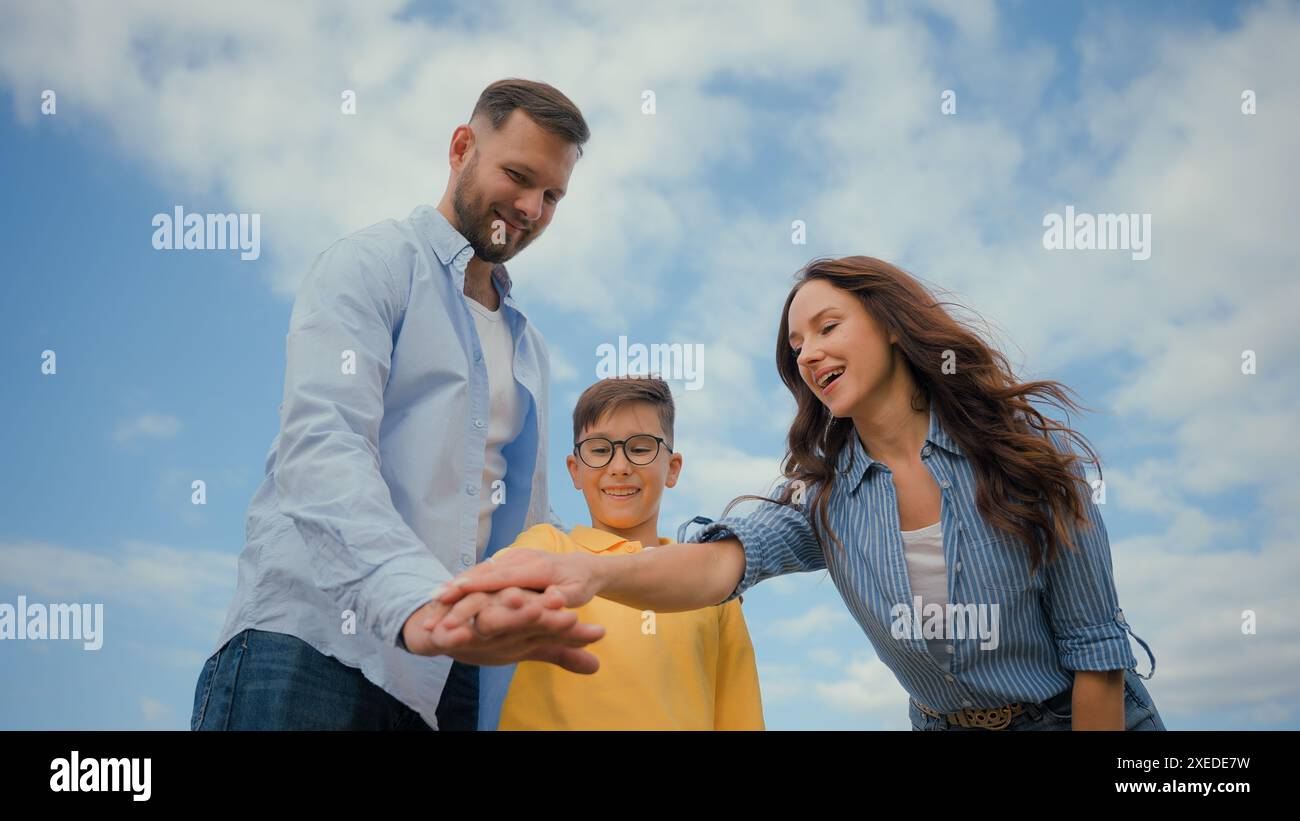 Low angle happy friendly Caucasian family parents mother father little ...