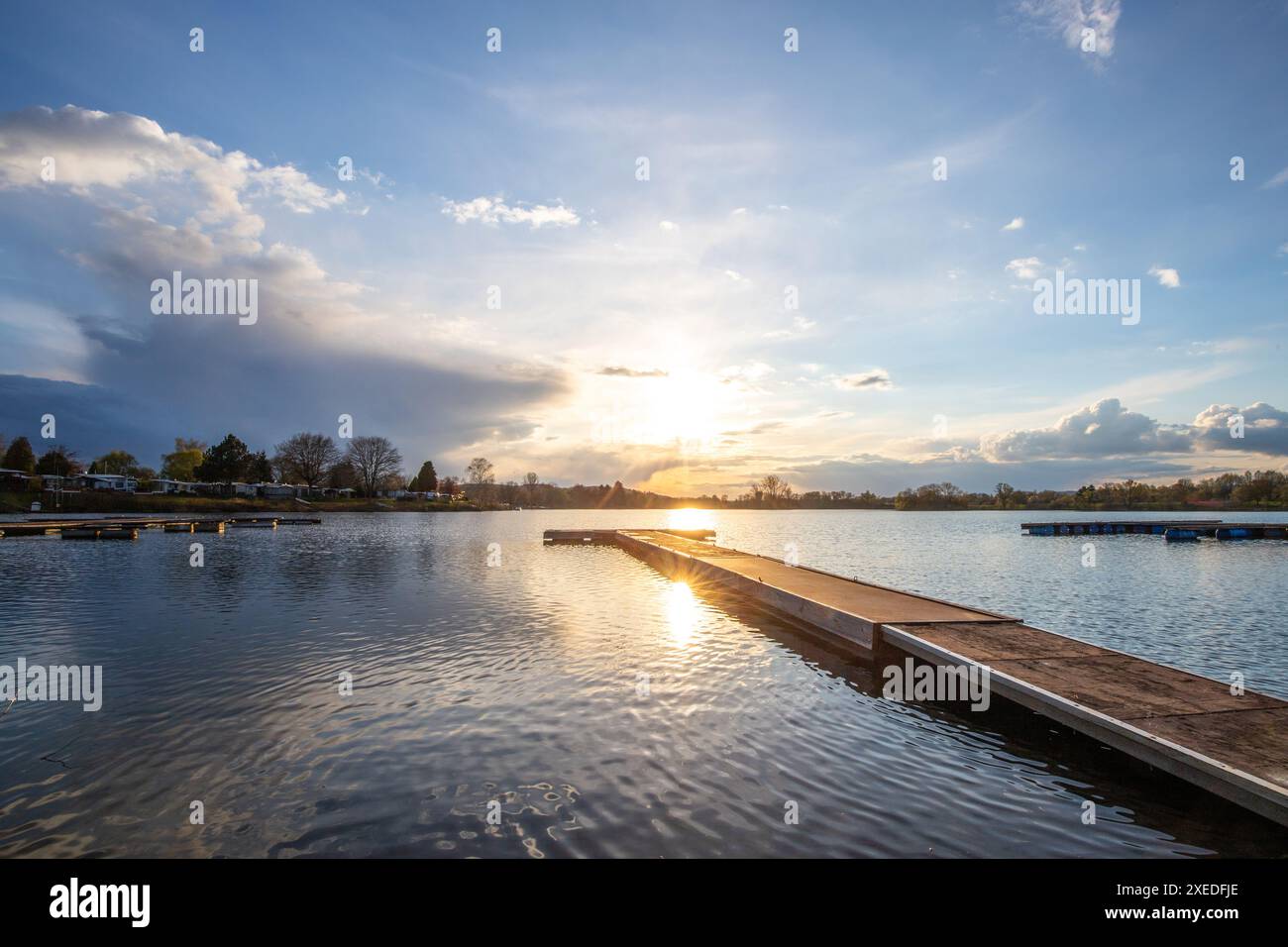 Sunset on a quiet lake in a valley surrounded by a forest Dutenhofener ...