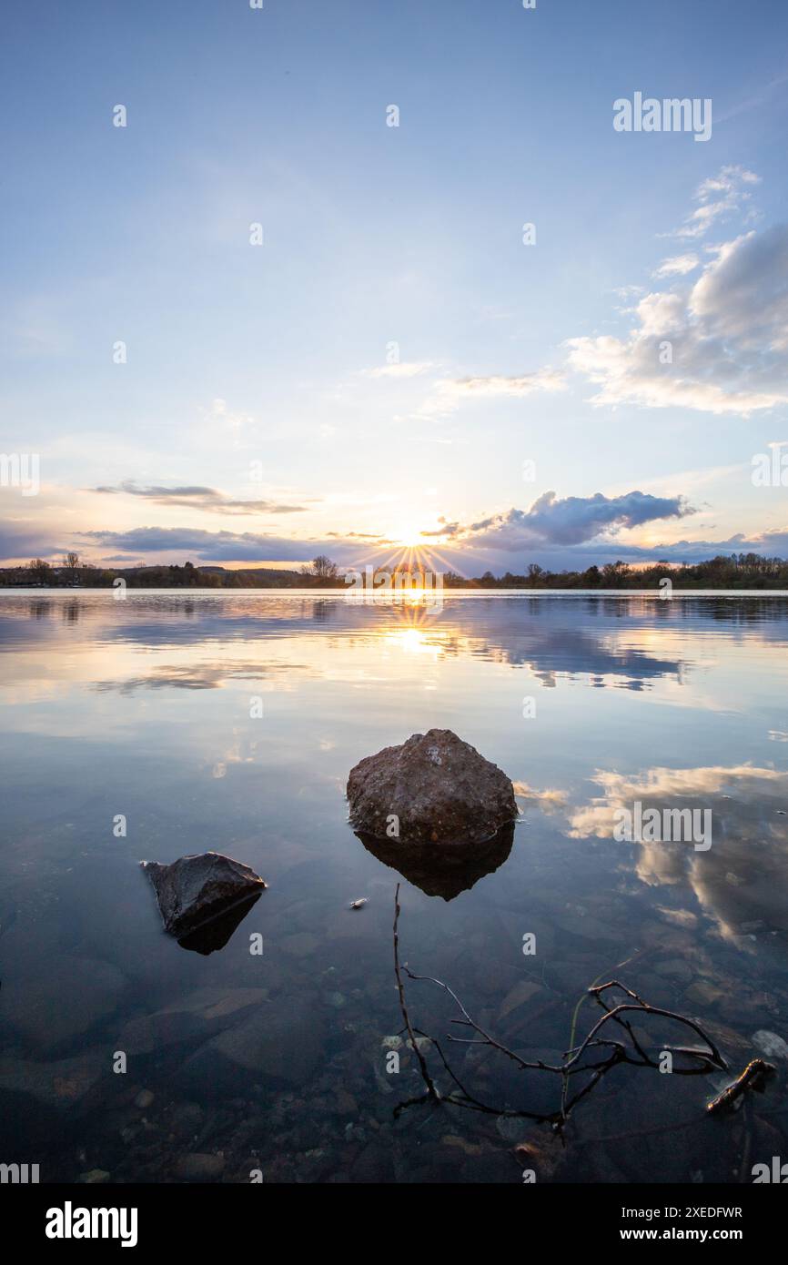 Sunset on a quiet lake in a valley surrounded by a forest Dutenhofener ...