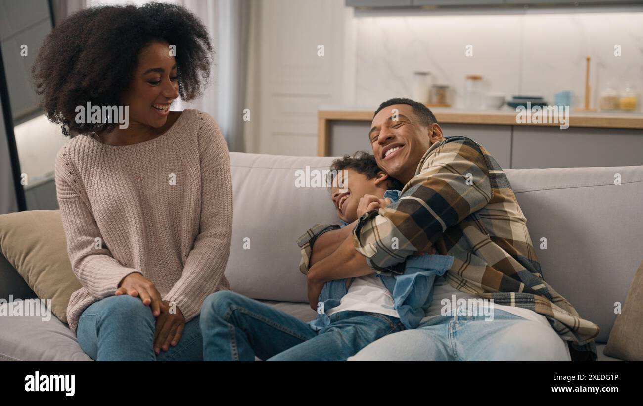 Happy family having fun African American joyful couple female mom woman ...