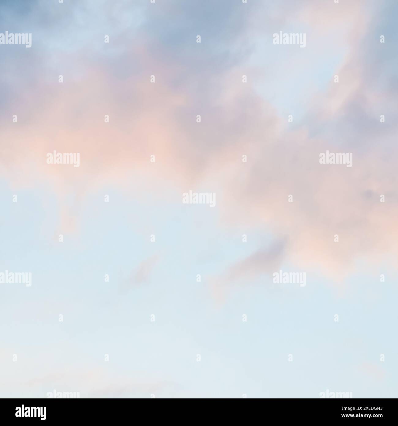 Blue sky background with pale pink clouds at sunset Stock Photo - Alamy