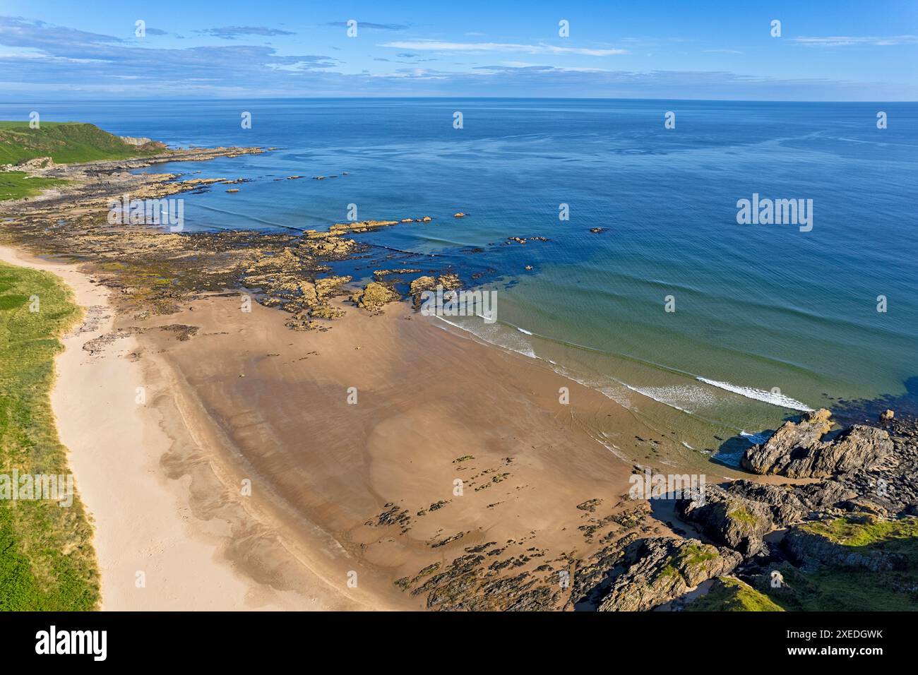 Sunnyside Beach and Bay Cullen Scotland a blue sky green blue sea and a ...