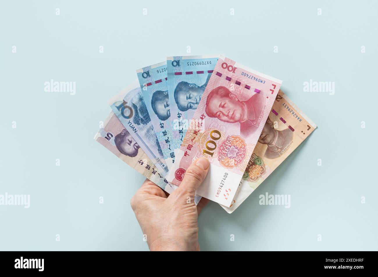 Many of different Chinese yuan banknotes in female hand. Chinese paper ...