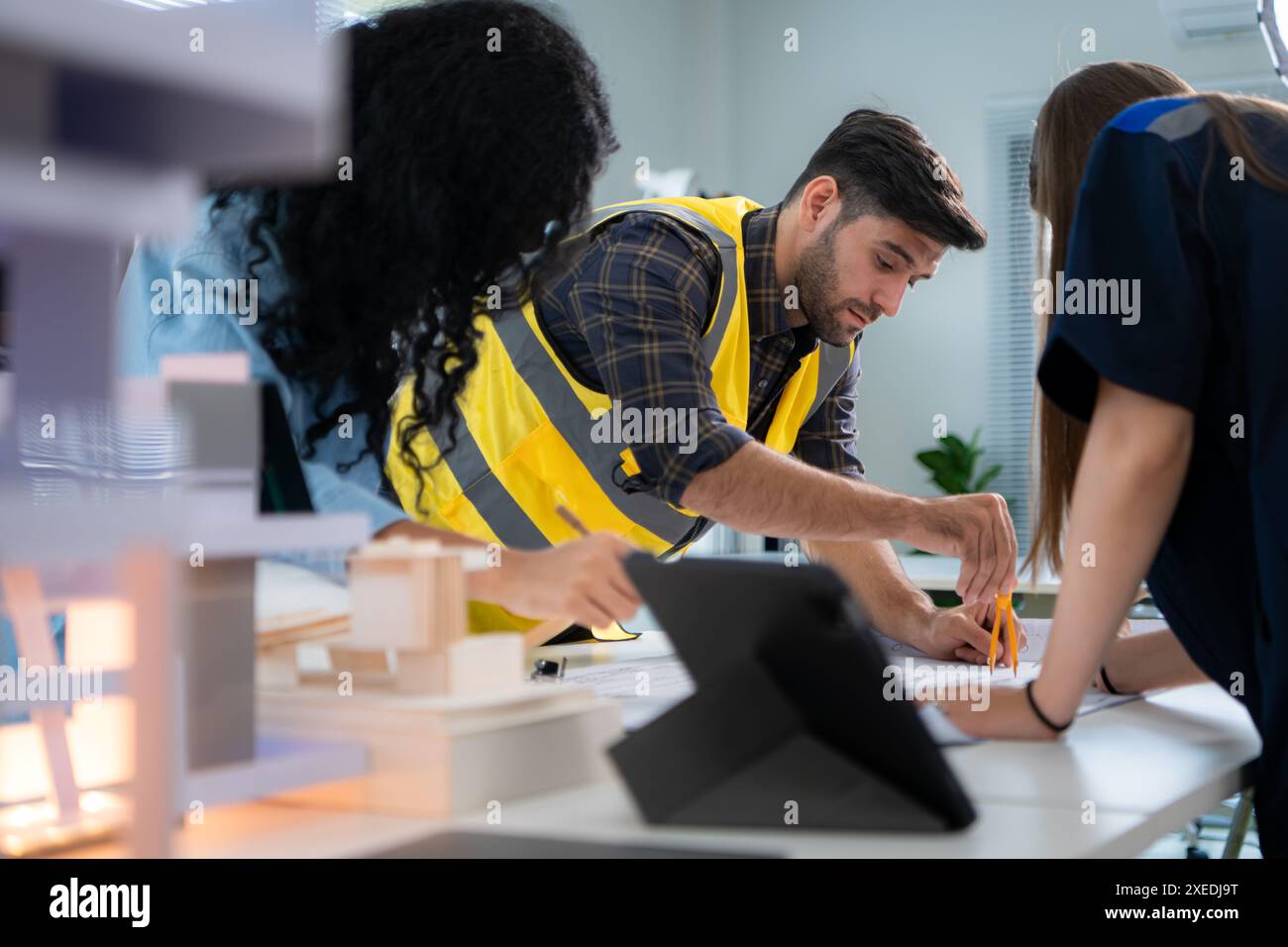 Engineers, architects, and designers collaborate to design a building ...