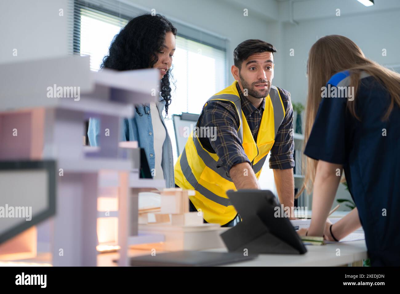 Engineers, architects, and designers collaborate to design a building ...