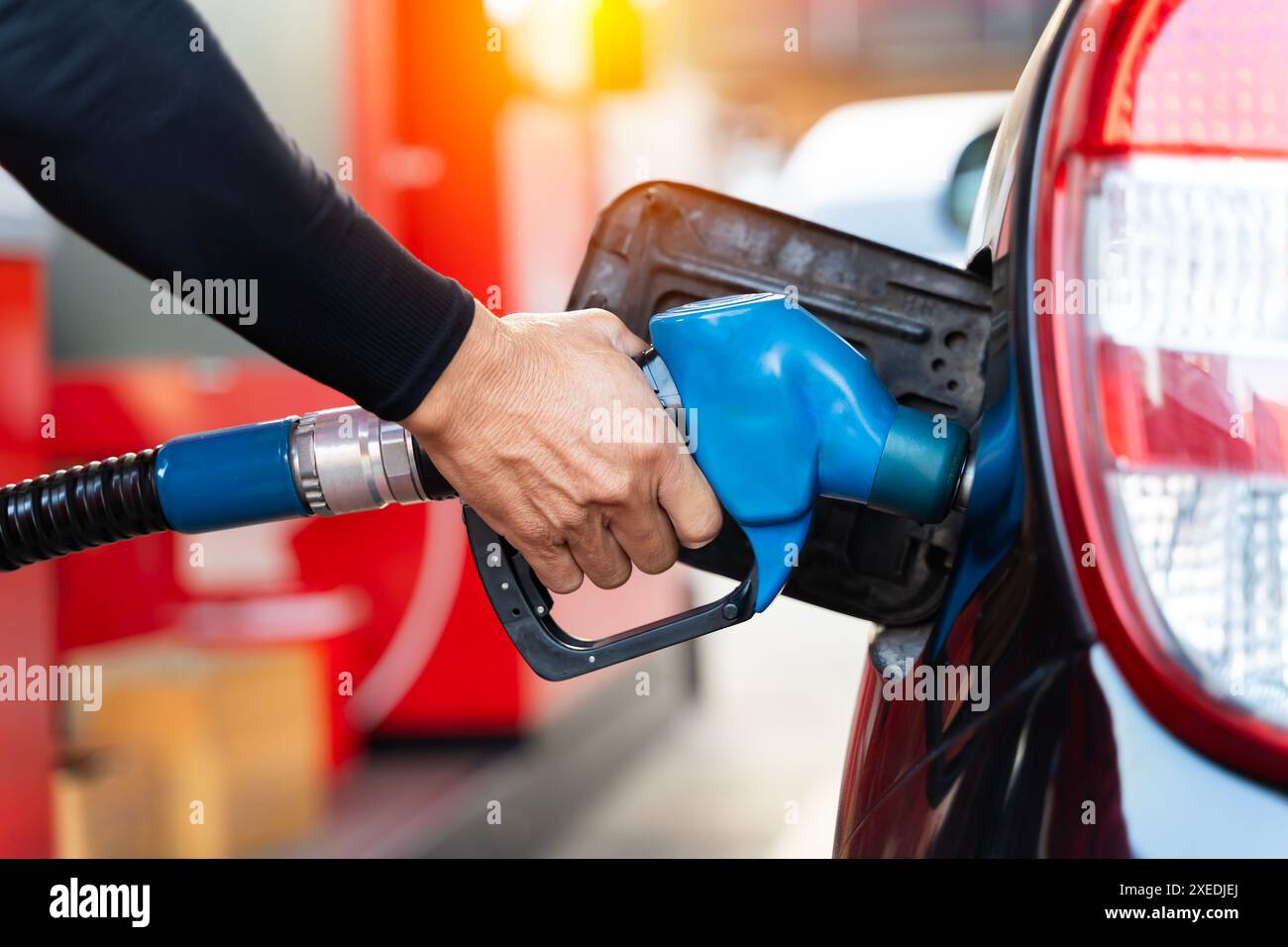 Refueling the car at a gas station fuel pump. Man driver hand refilling ...