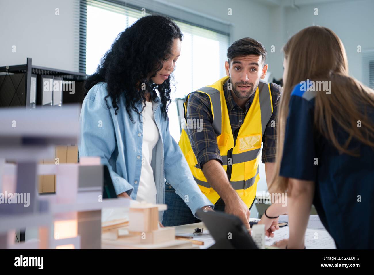 Engineers, architects, and designers collaborate to design a building ...
