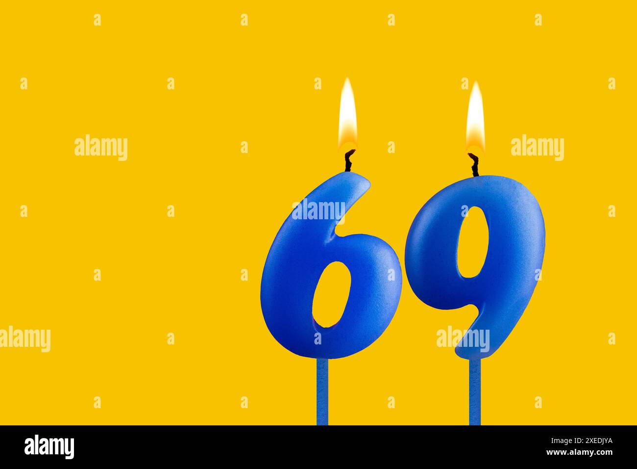 Blue birthday candle on yellow background - Number 69 Stock Photo - Alamy