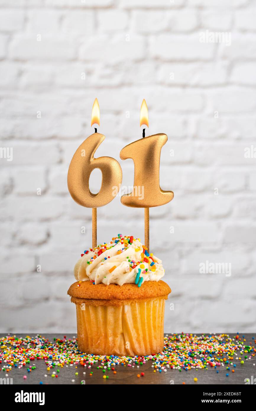 Golden birthday candle number 61 with cupcake - White block wall ...