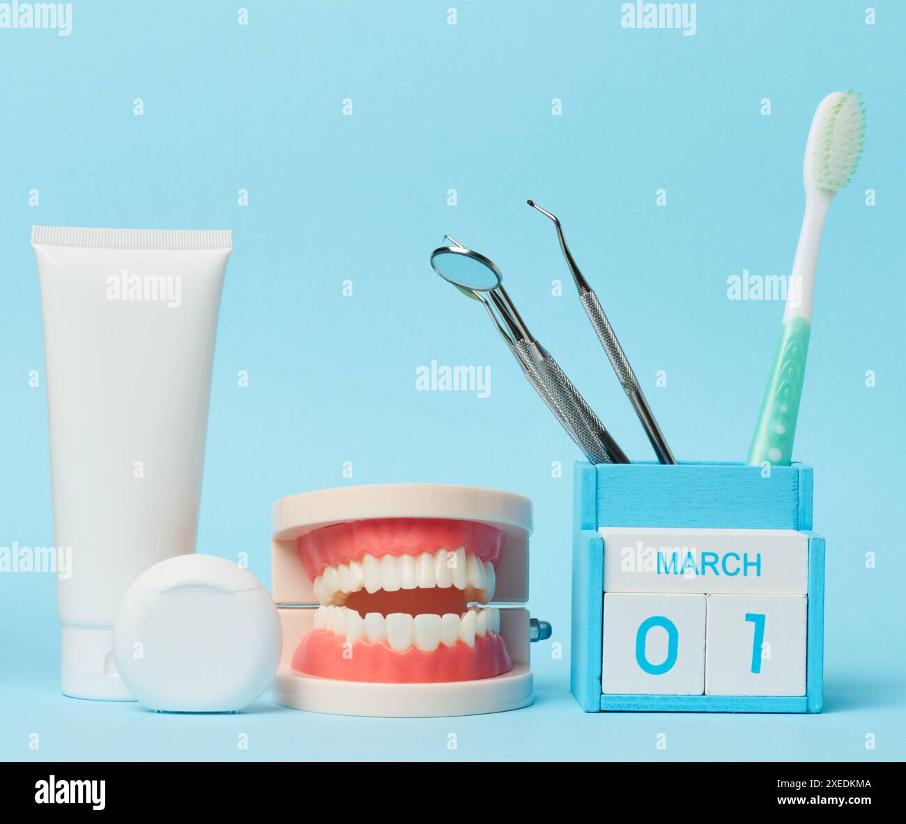 Plastic bottle with mouthwash, dentist medical instruments on blue ...