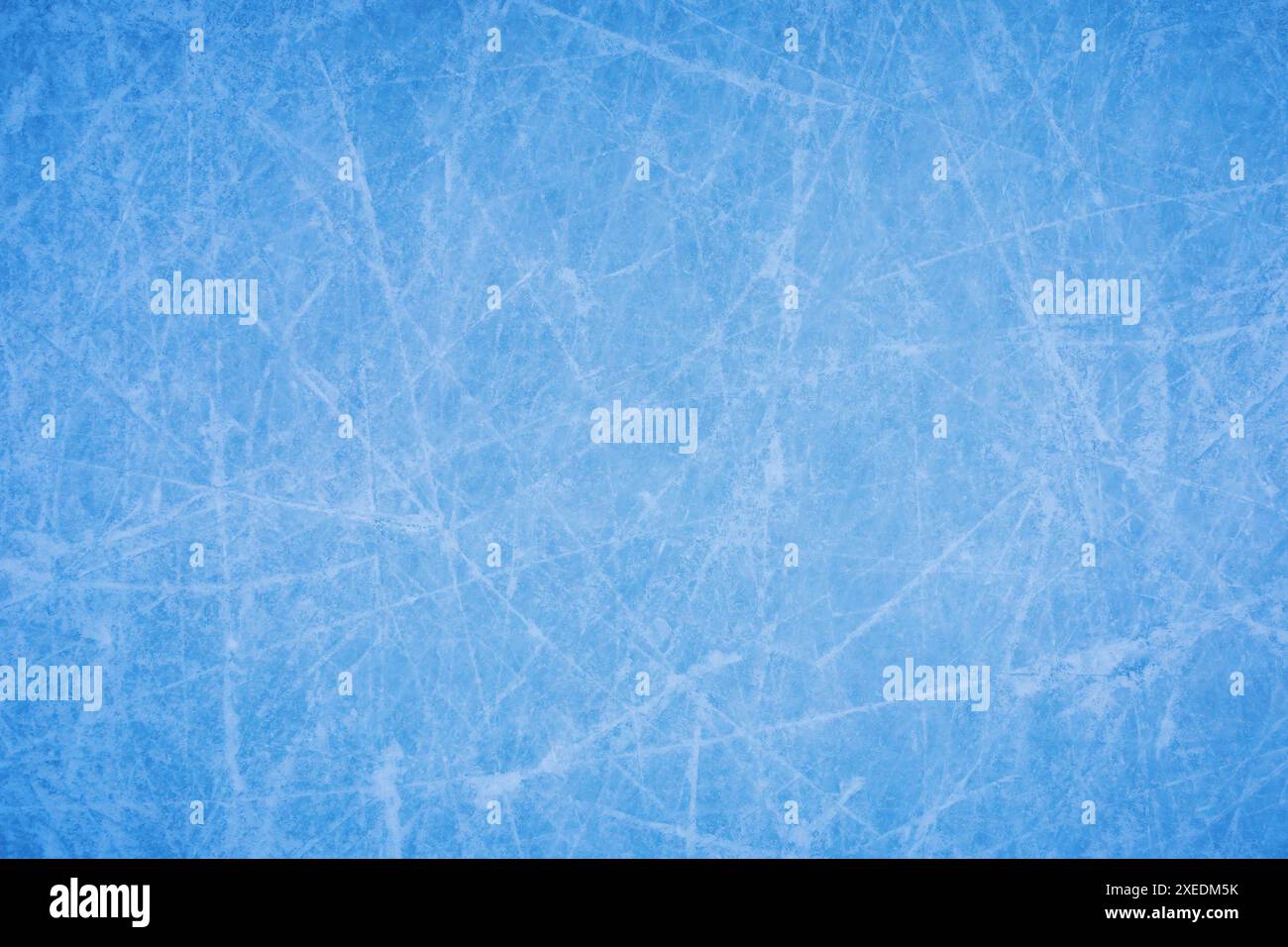 Ice background with marks from skating and hockey, blue texture of rink ...