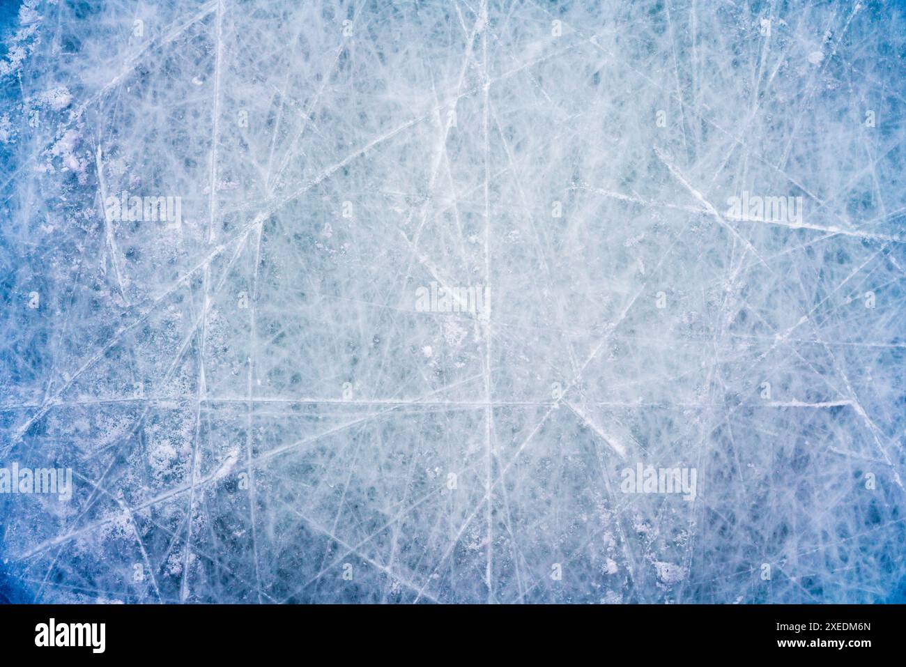 Ice background with marks from skating and hockey, blue texture of rink ...