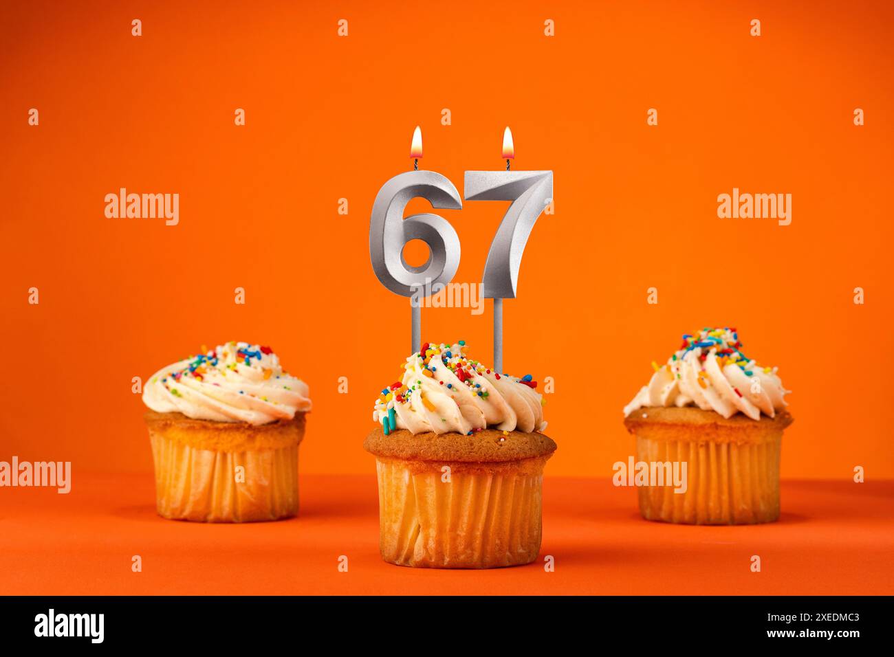 Candle number 67 - Celebration with birthday cupcake on orange ...