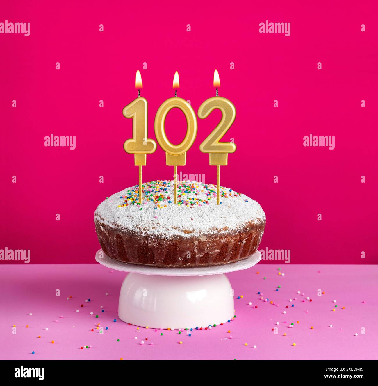 Lighted birthday candle number 102 - Birthday card on pink background ...