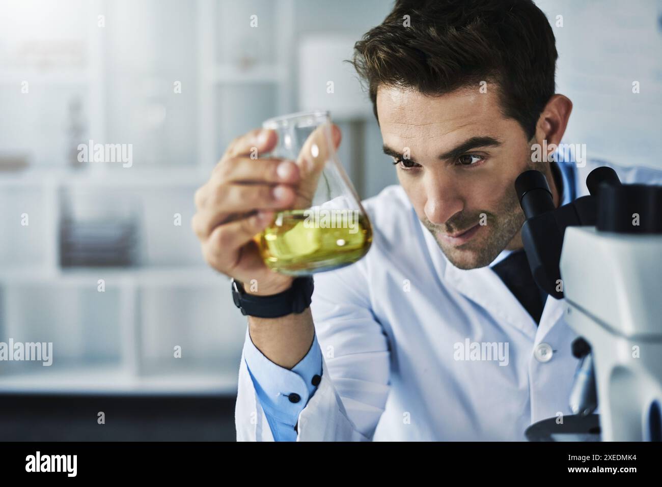 Man, beaker and scientist with liquid in laboratory for clinical ...