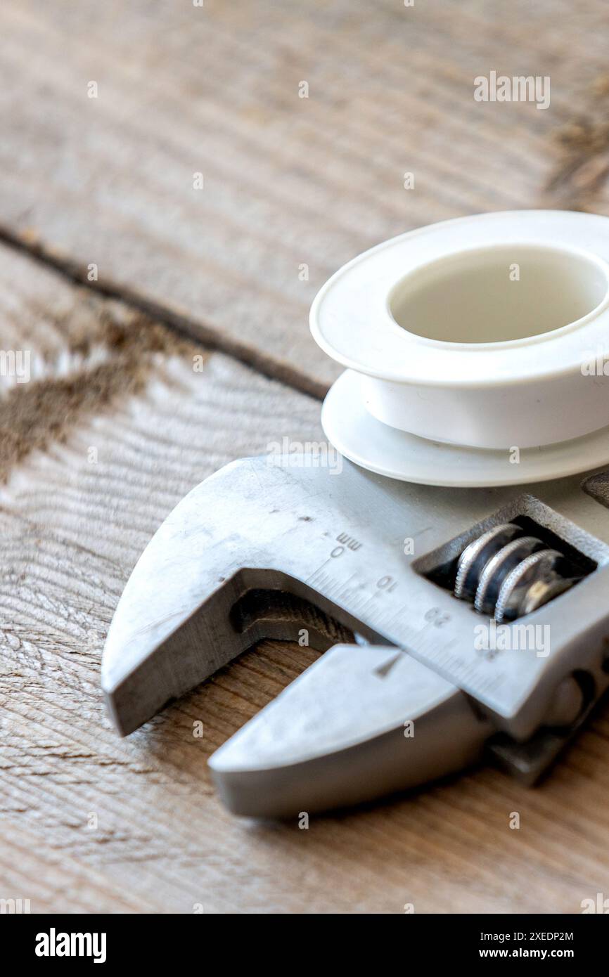 Plumbing parts, sealing tape, adjustable wrench Stock Photo - Alamy