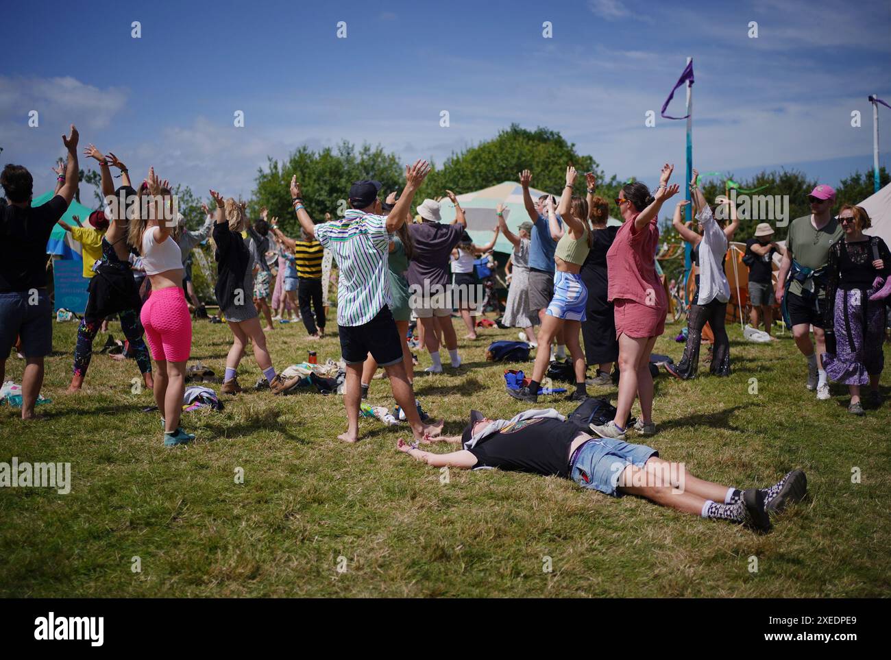 Festivalgoers taking part in a Qigong open air workshop in the healing ...