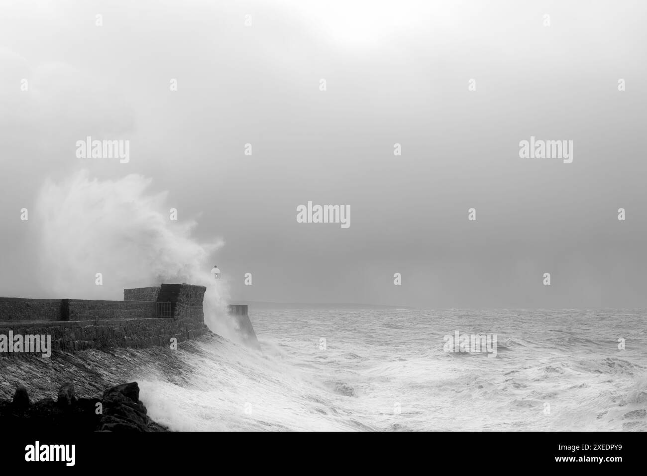 Black and white image of a wave crashing over Porthcawl's breakwater ...