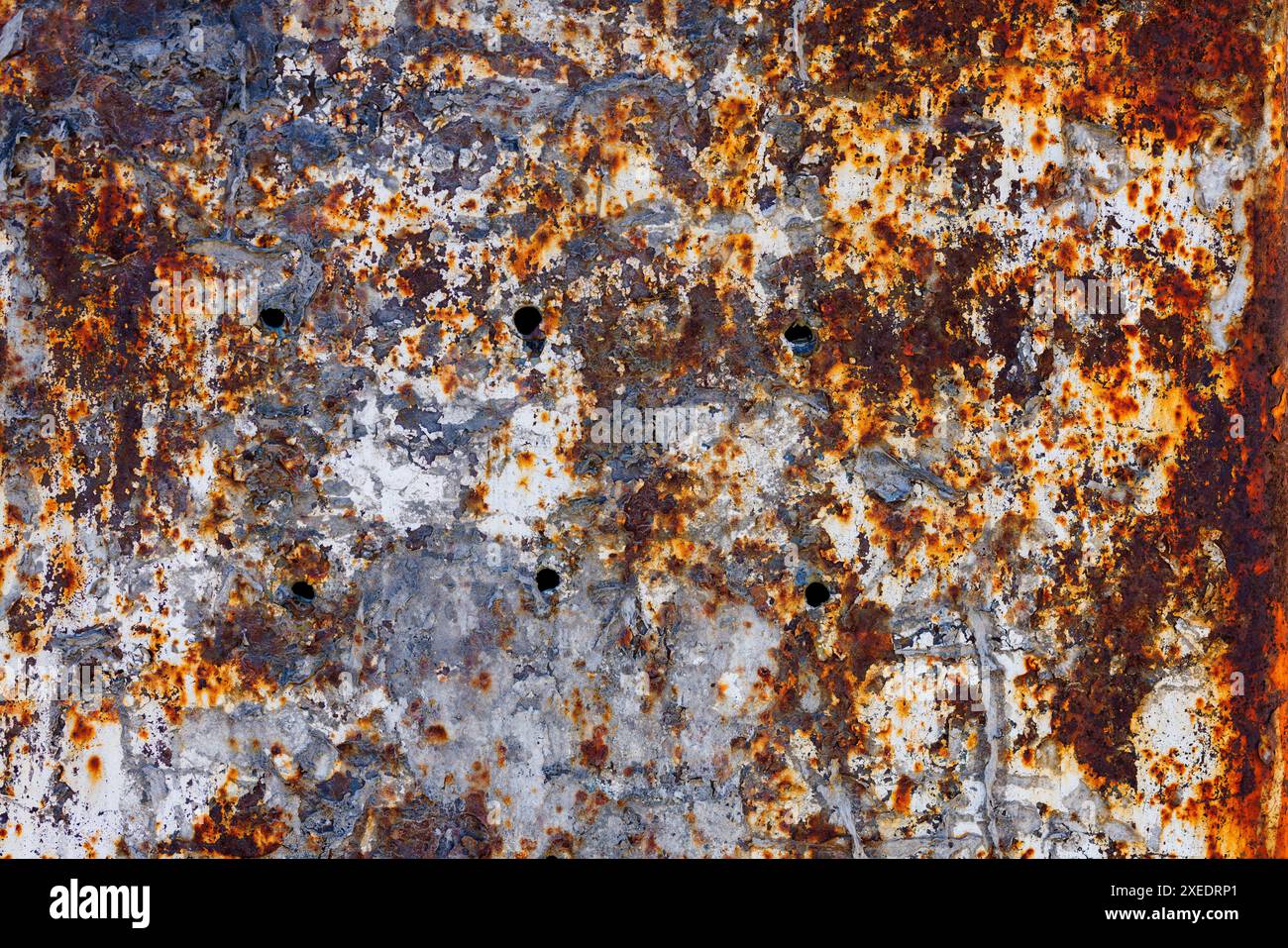 Rusty iron wall with thick layer of eroded and peeled off old paint and ...