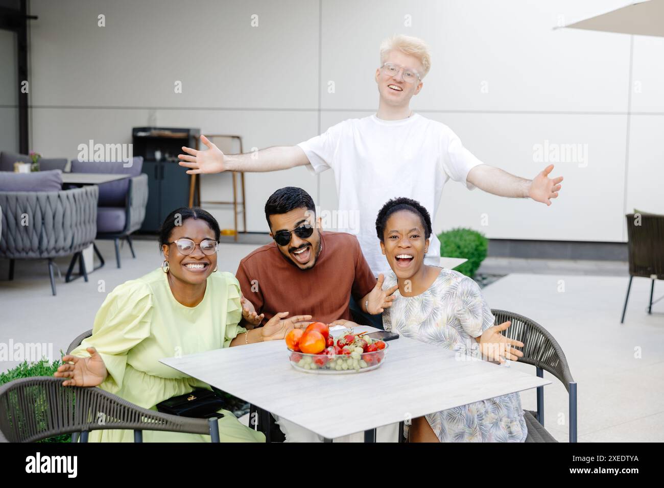 Multinational friends having fun in outdoor cafe in summer time Stock ...