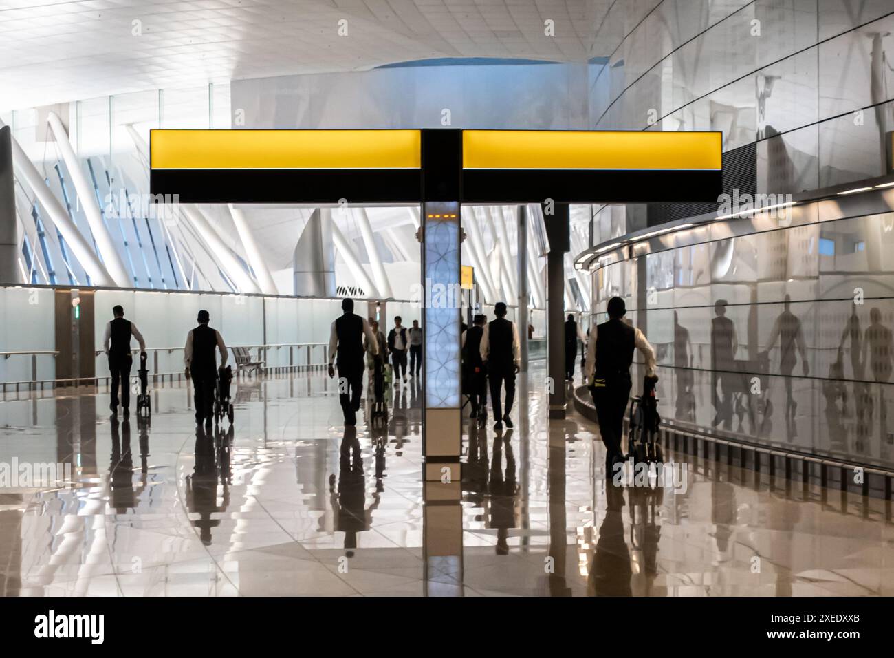Airport staff with folded wheelchairs walking in the terminal, Zayed ...