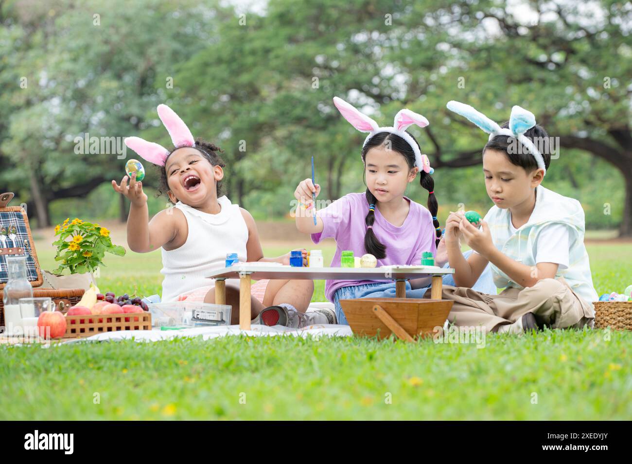 Happy family enjoying a picnic in the park, Children sitting and ...