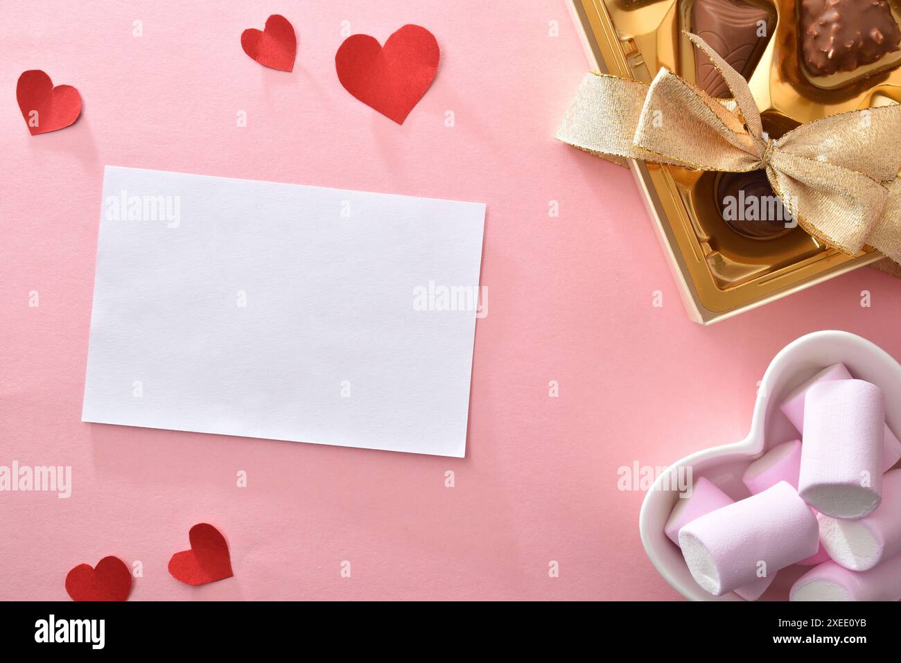 Blank card and box of chocolates with golden bow and container full of ...