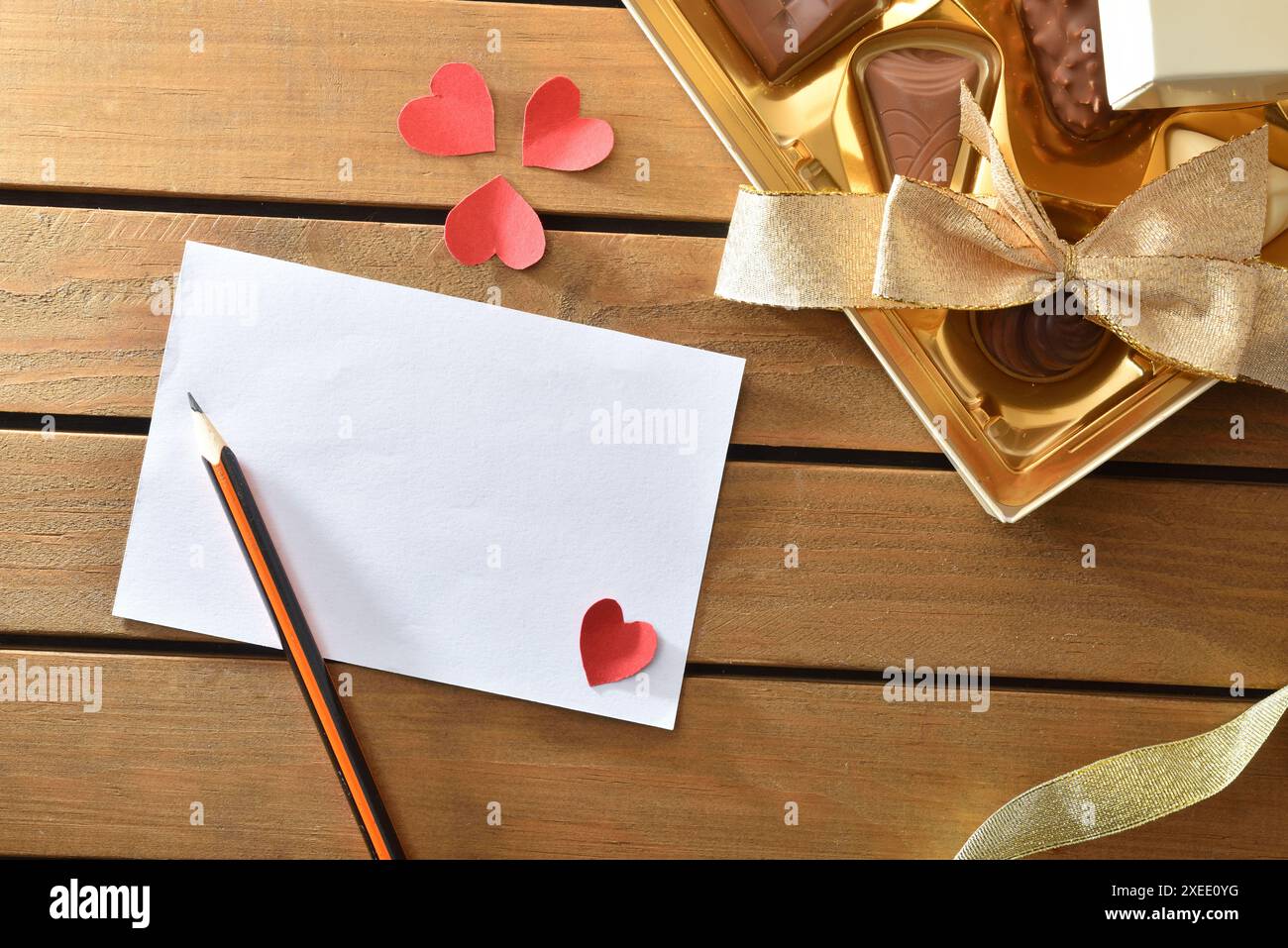 Empty card to write words of love with pencil on wooden table with box ...