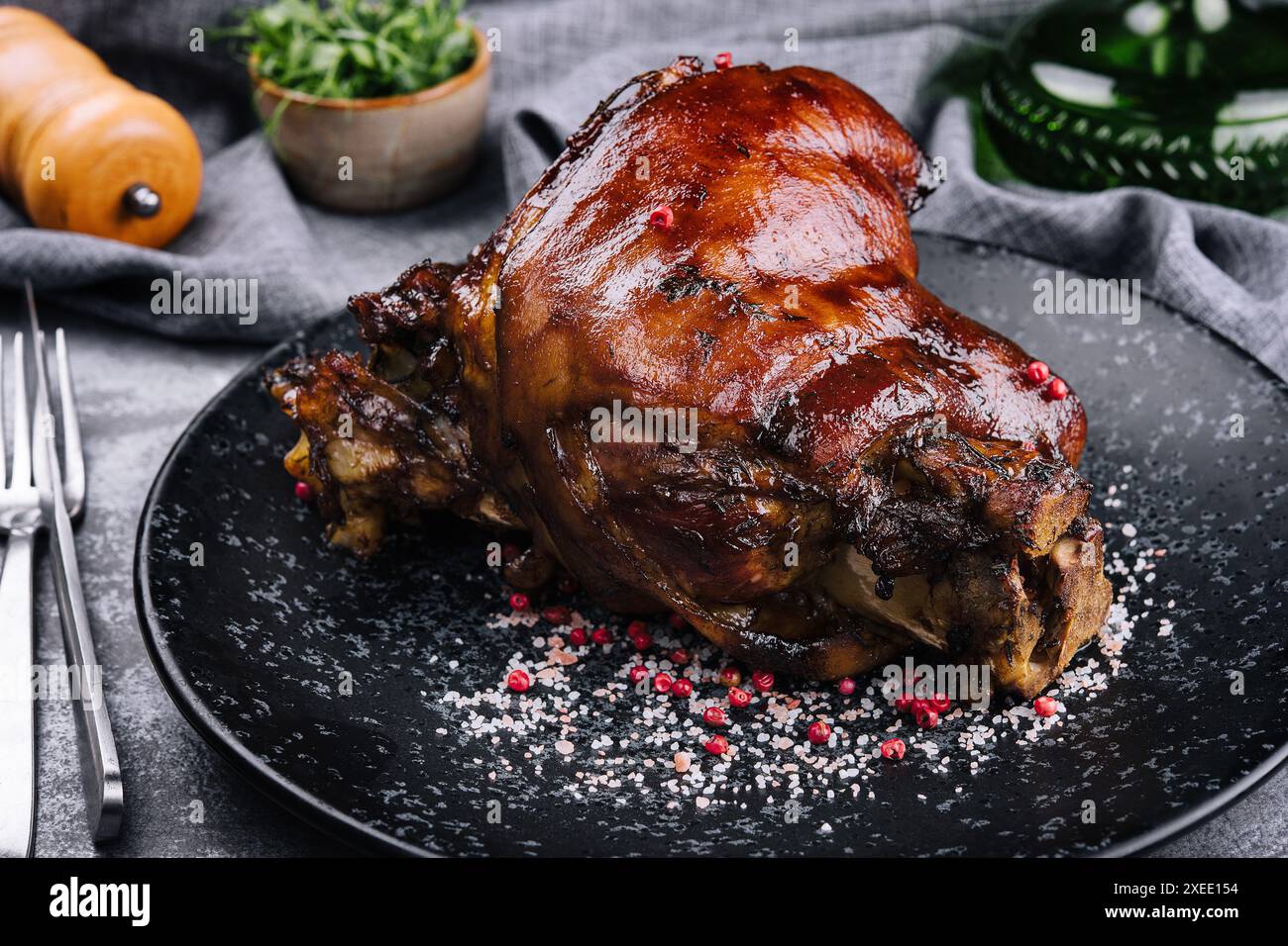 Roast pork knuckle on black plate Stock Photo - Alamy