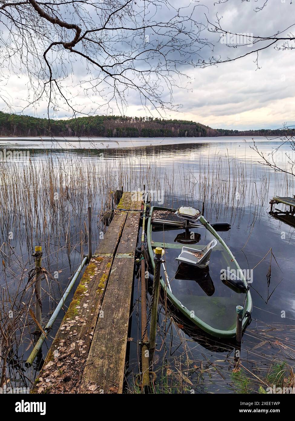 Fully flooded fishing boat in the lake Stock Photo - Alamy