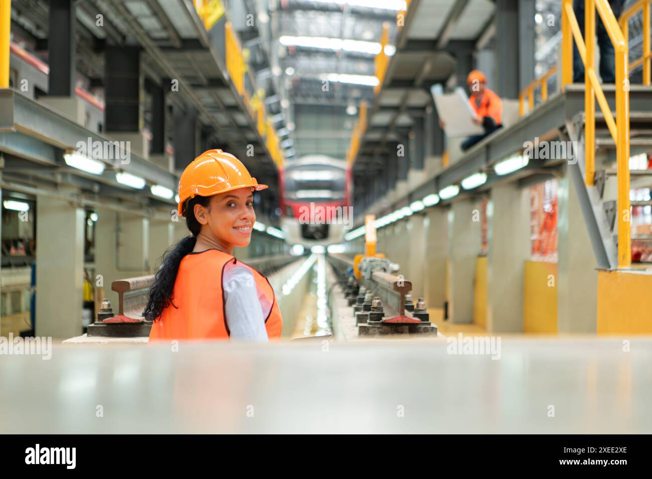 Portrait of a young female engineer standing in the skytrain repair ...