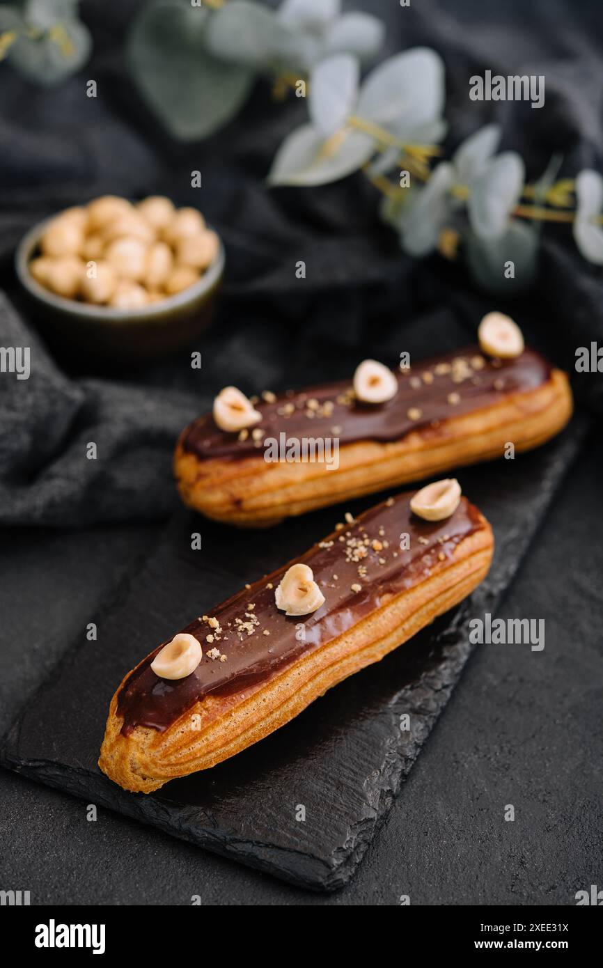 french eclairs with chocolate and hazelnuts Stock Photo - Alamy