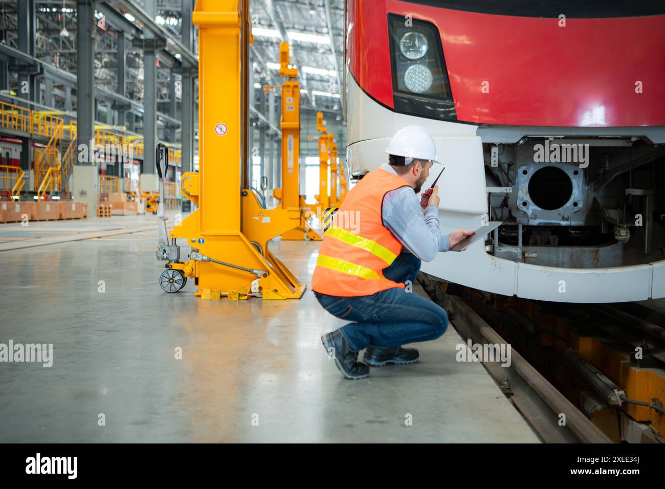 Portrait of a young male technician using a tablet working and standing ...