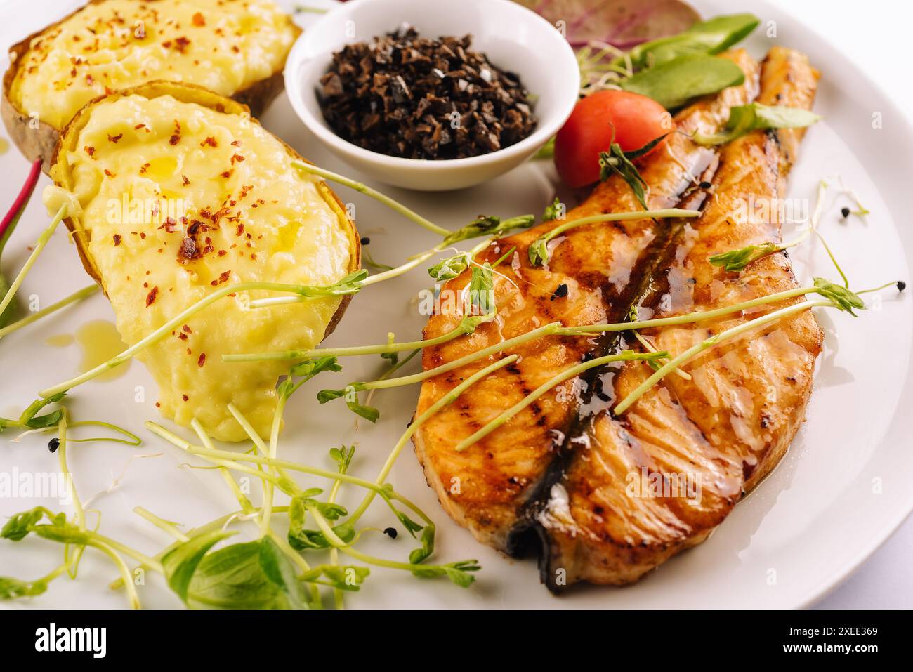 Salmon fillet with mashed potatoes in baked potato skins Stock Photo ...