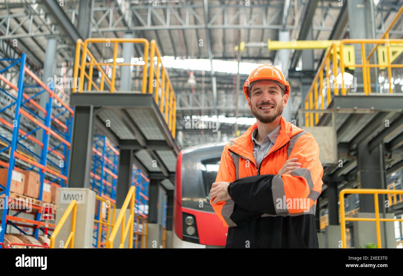 Portrait of Young male technician standing in the front of head of ...