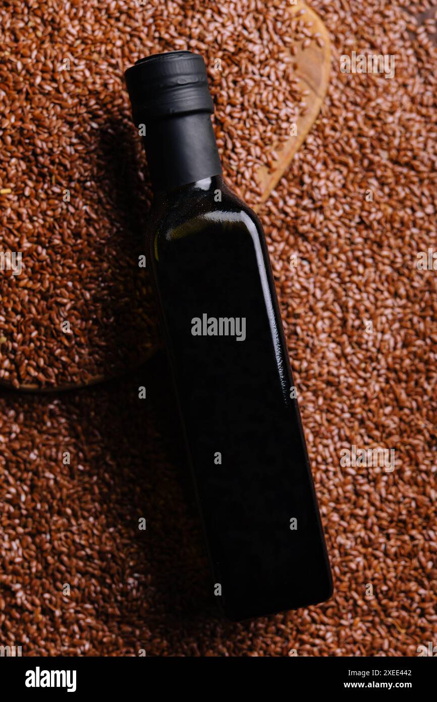 linseed oil bottle with linseed background Stock Photo - Alamy