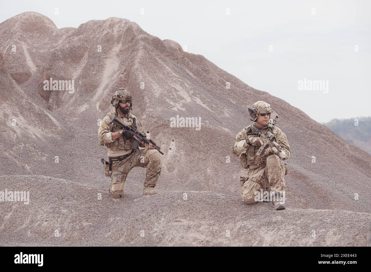 Soldiers in camouflage military uniforms carrying weapons ...